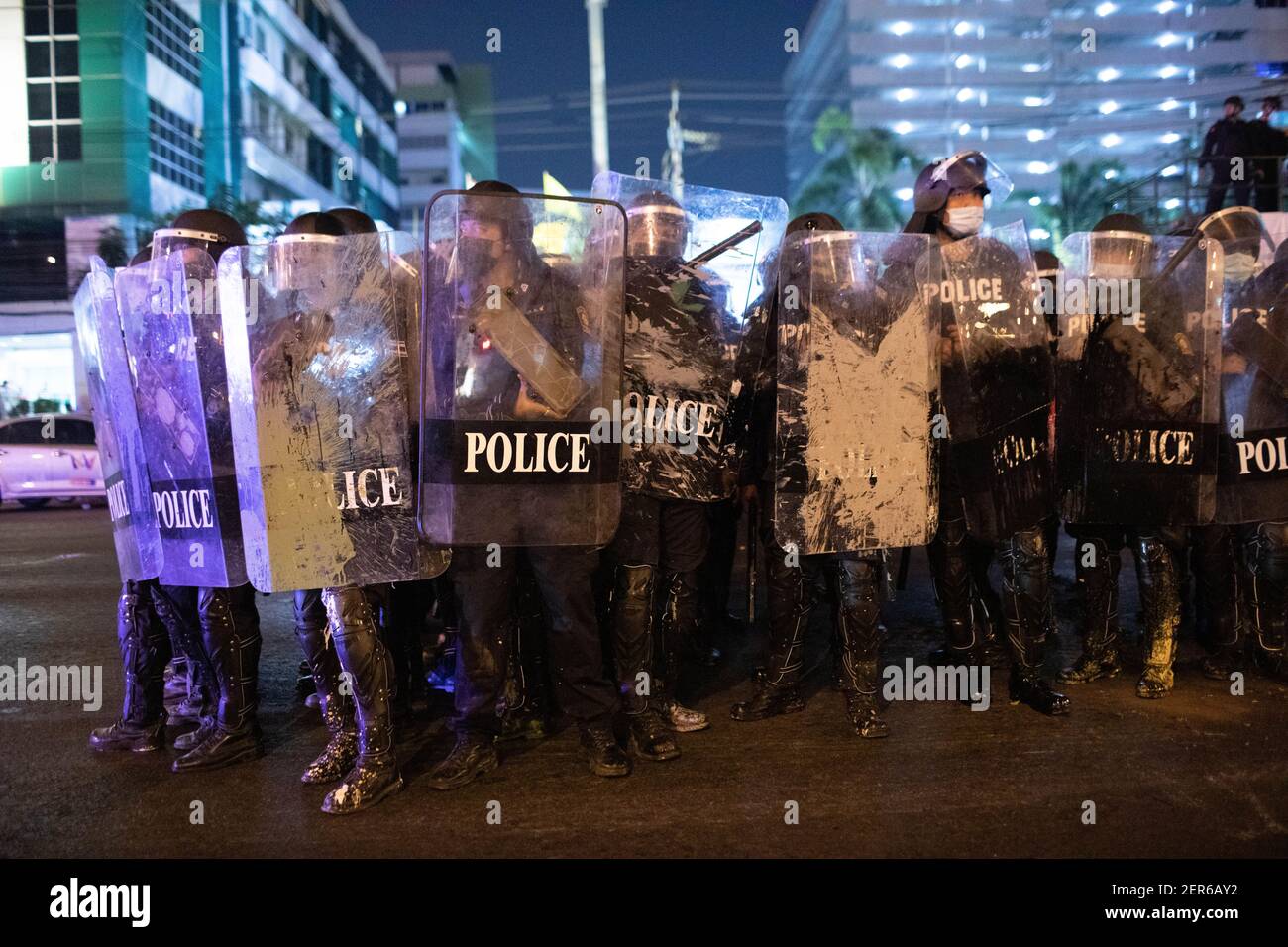 Riot police stand guard behind their shields during an anti-government ...