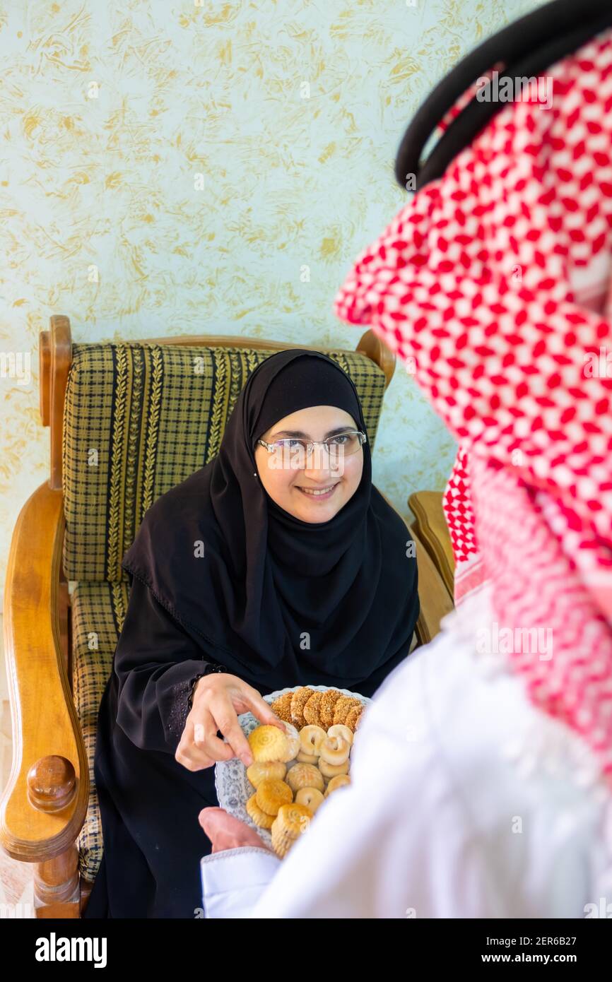 Muslim man serving sweets for his guest Stock Photo - Alamy