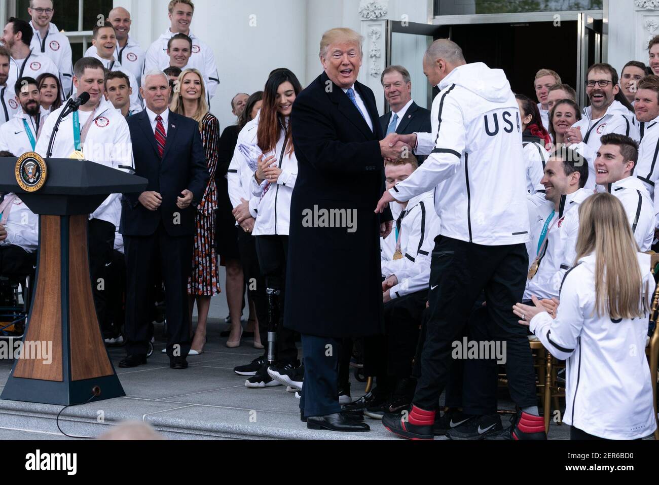 U.S. President Donald Trump (L), helps sled hockey gold medalist ...
