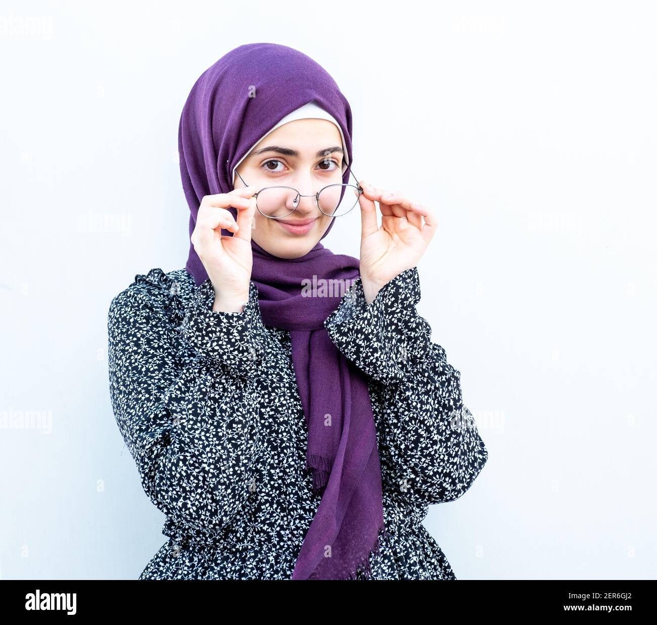 Arabic muslim girl holding her glasses on her face Stock Photo - Alamy
