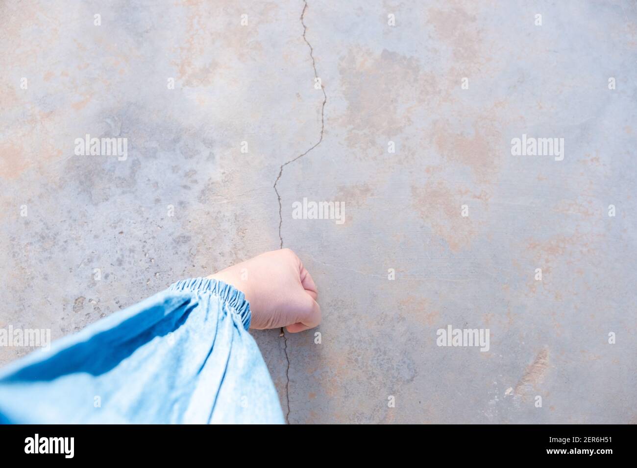 Girl punches the floor and break it with her hand Stock Photo - Alamy
