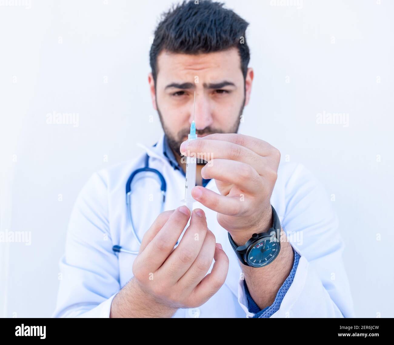 Arabic doctor holding needle in his hand Stock Photo - Alamy