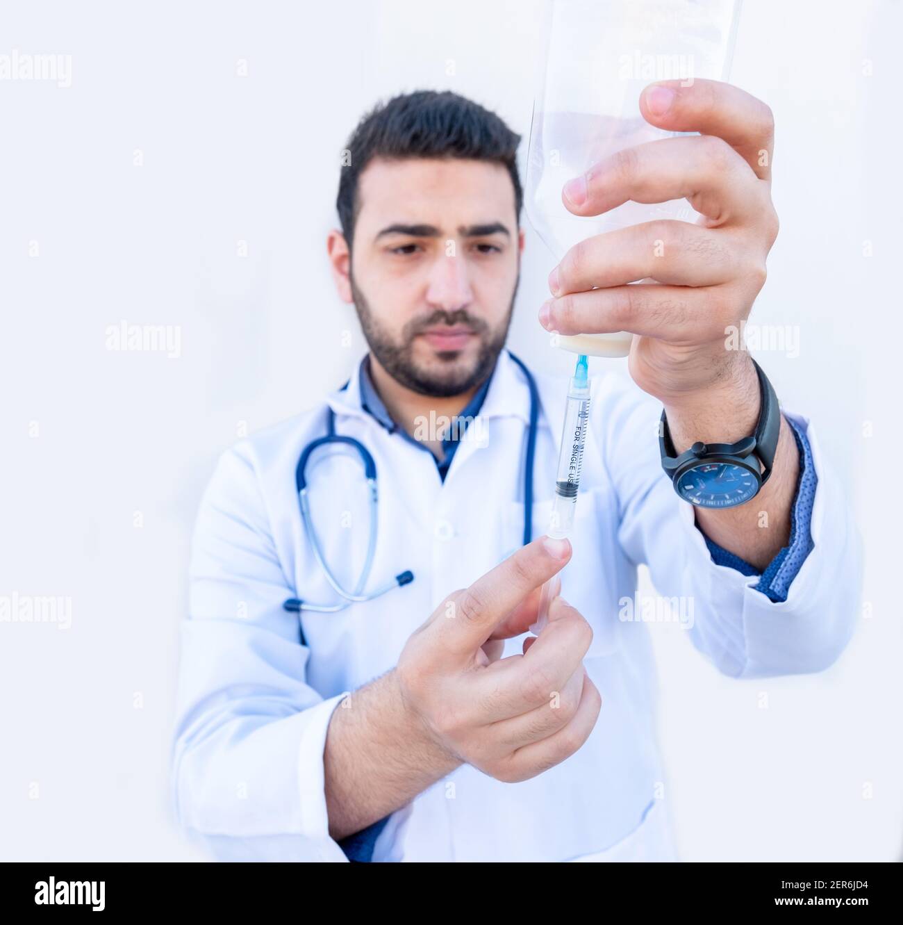 Arabic doctor holding needle in his hand Stock Photo - Alamy