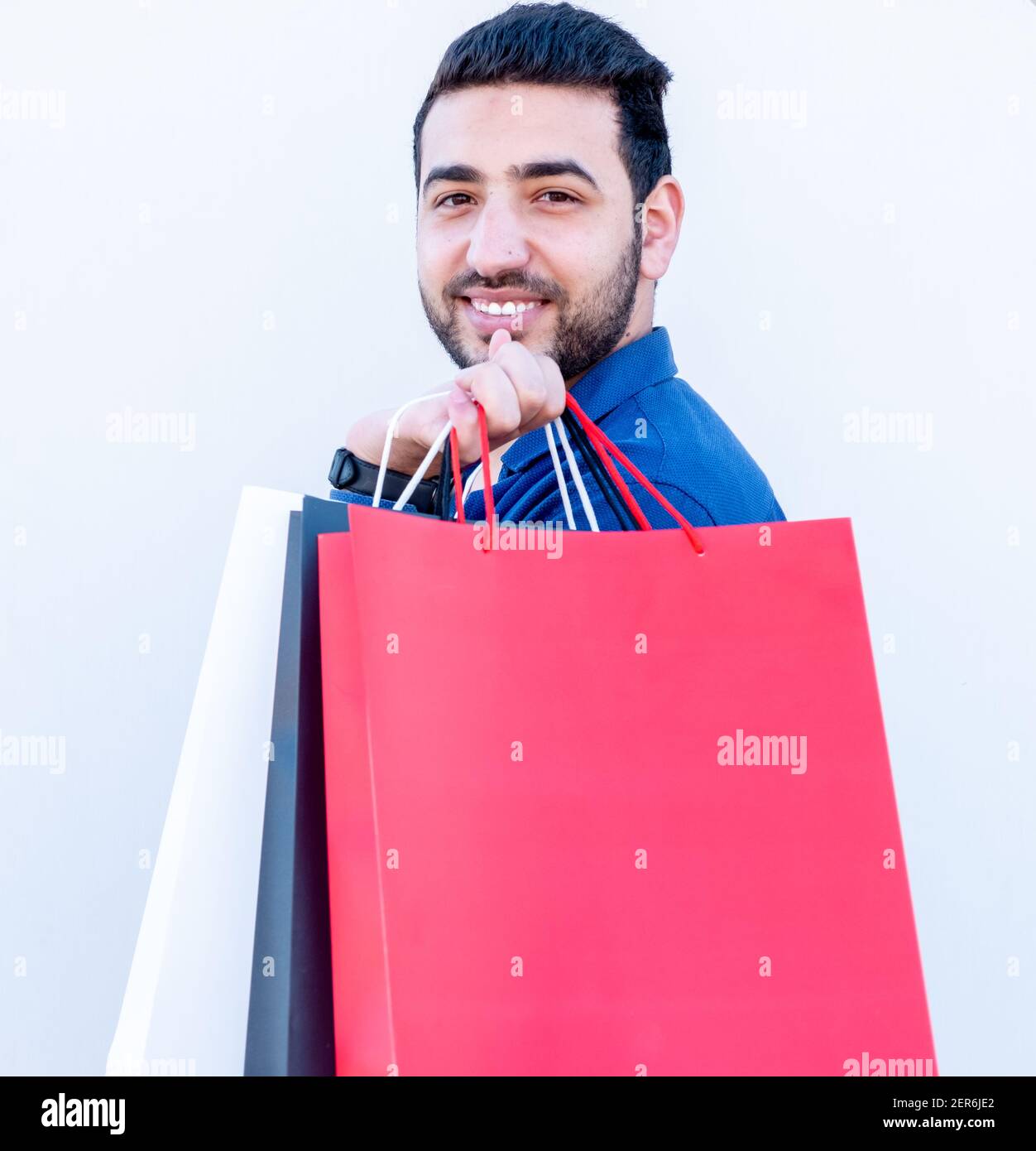 Arabic guy holding shopping bags in his hand Stock Photo - Alamy