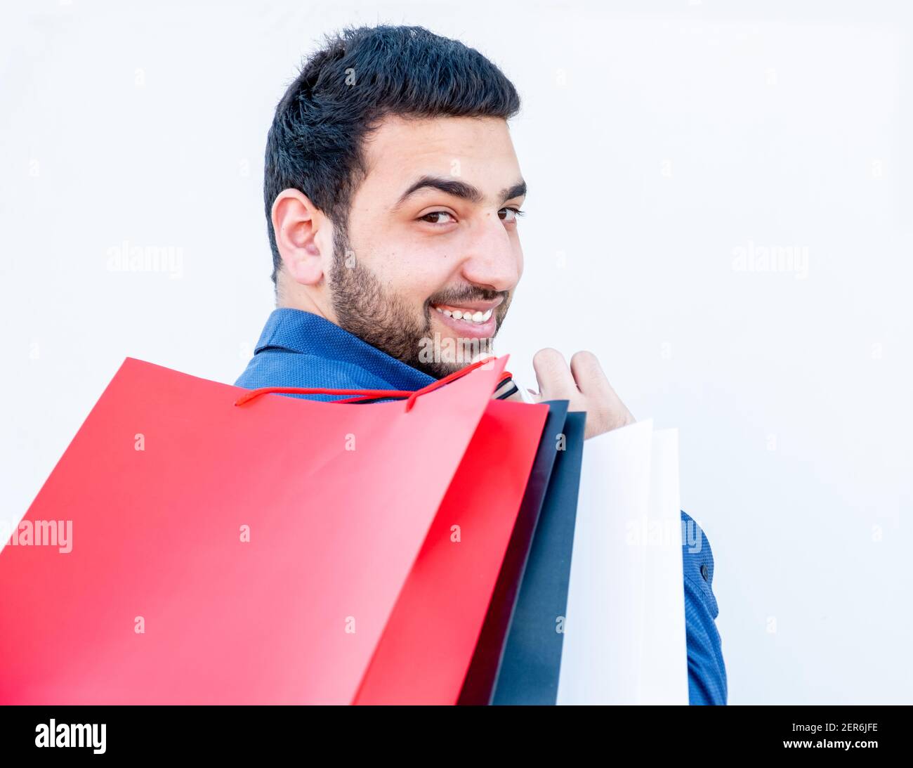 Arabic guy holding shopping bags in his hand Stock Photo - Alamy