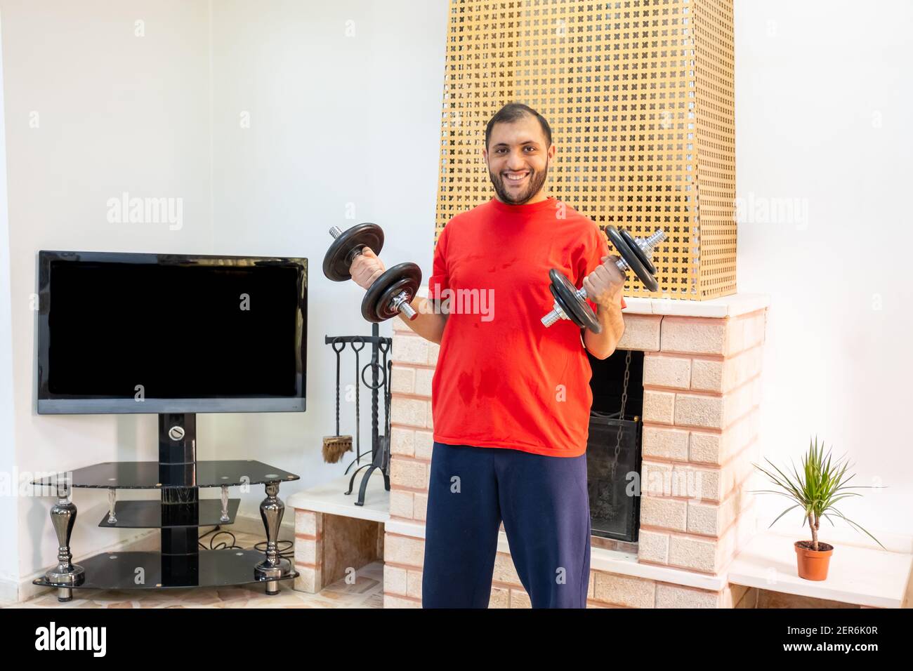Athletic guy training hard at his home Stock Photo - Alamy
