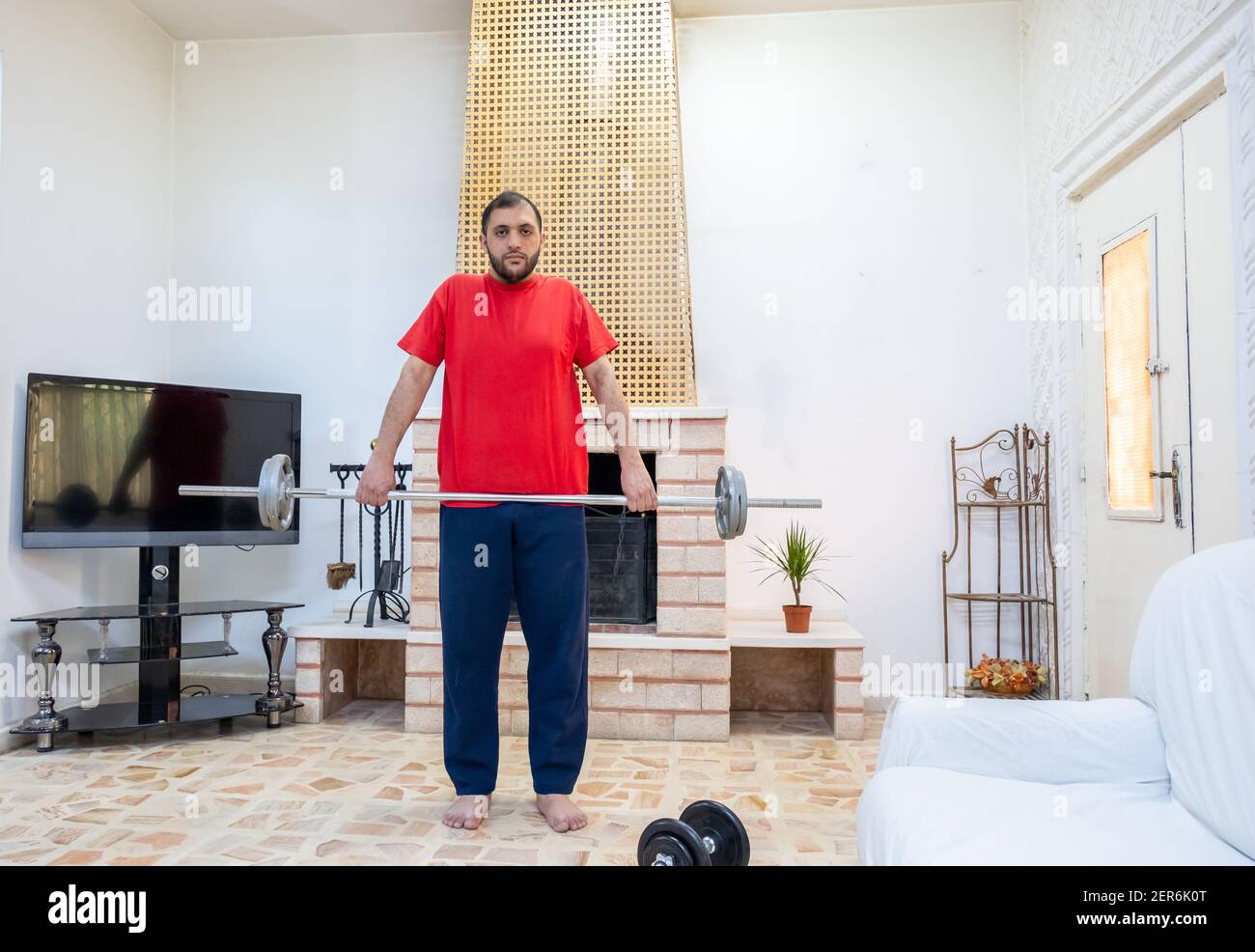 Athletic guy training hard at his home Stock Photo - Alamy