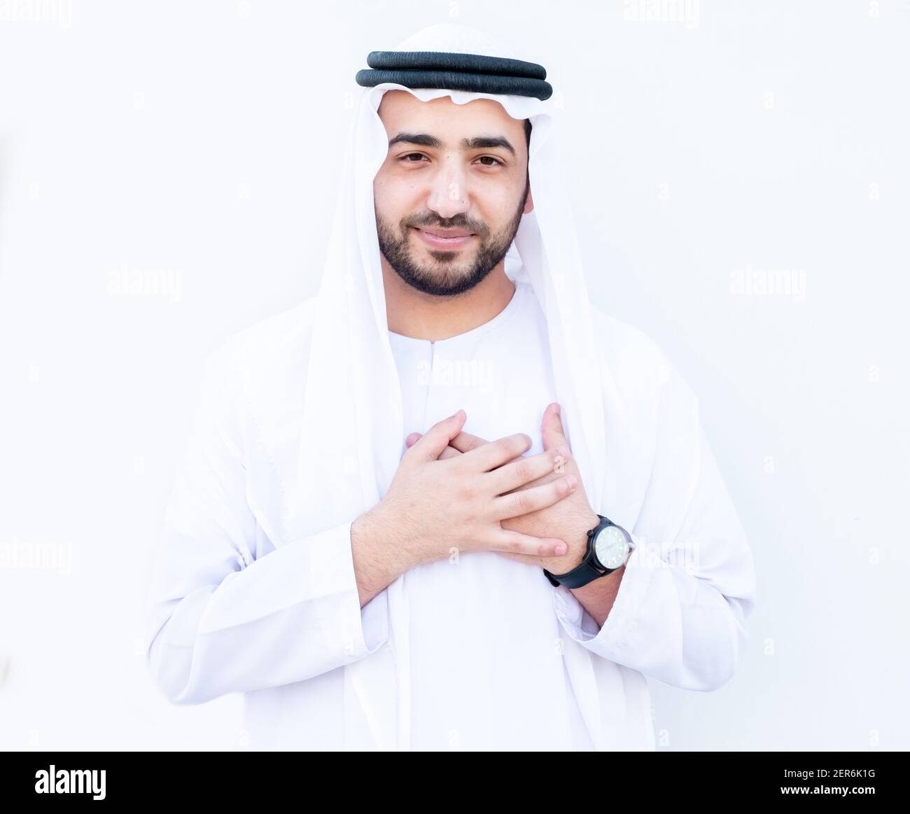 Arabic man feeling his heart beat by his hands Stock Photo - Alamy
