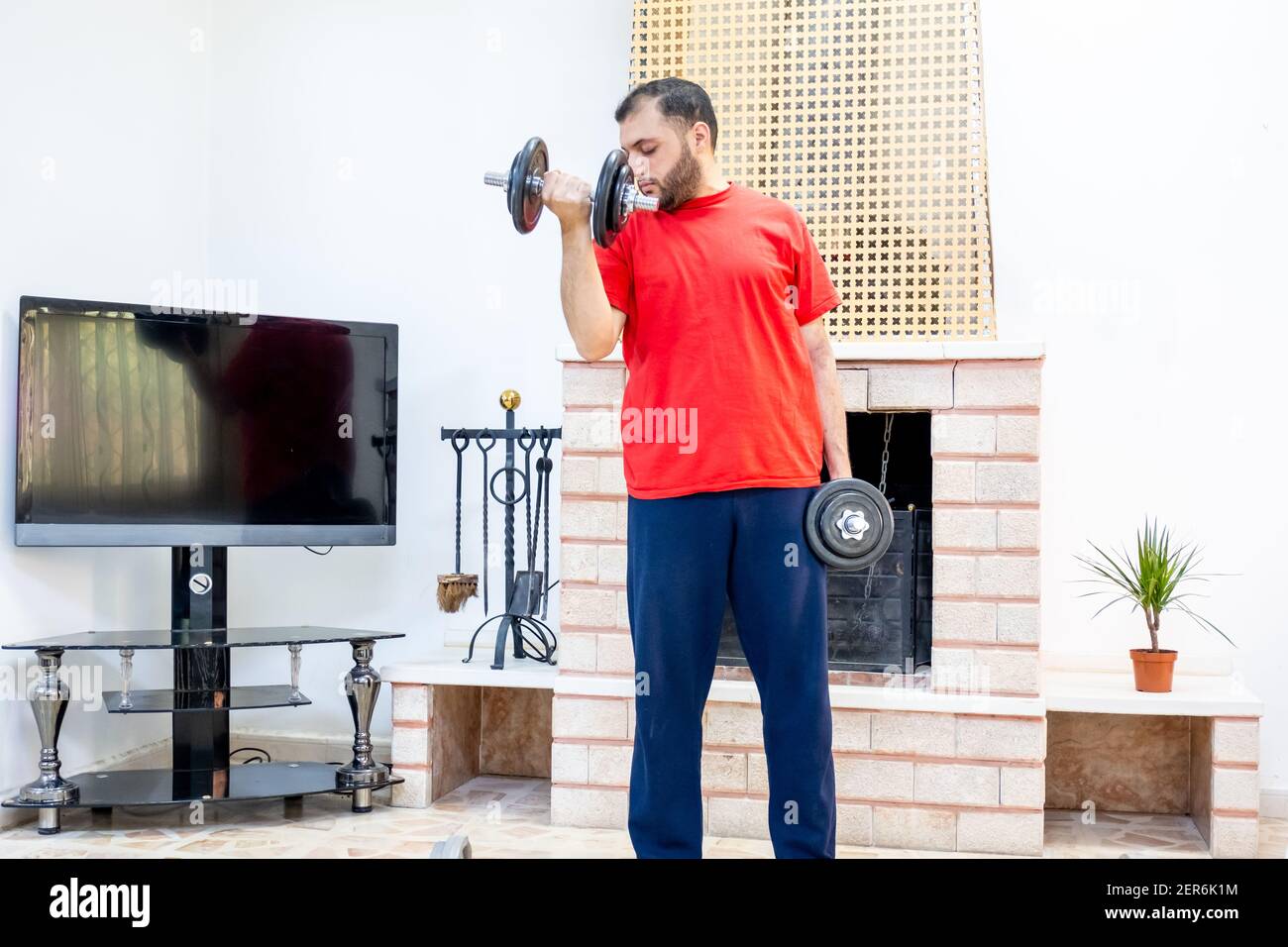 Athletic guy training hard at his home Stock Photo - Alamy