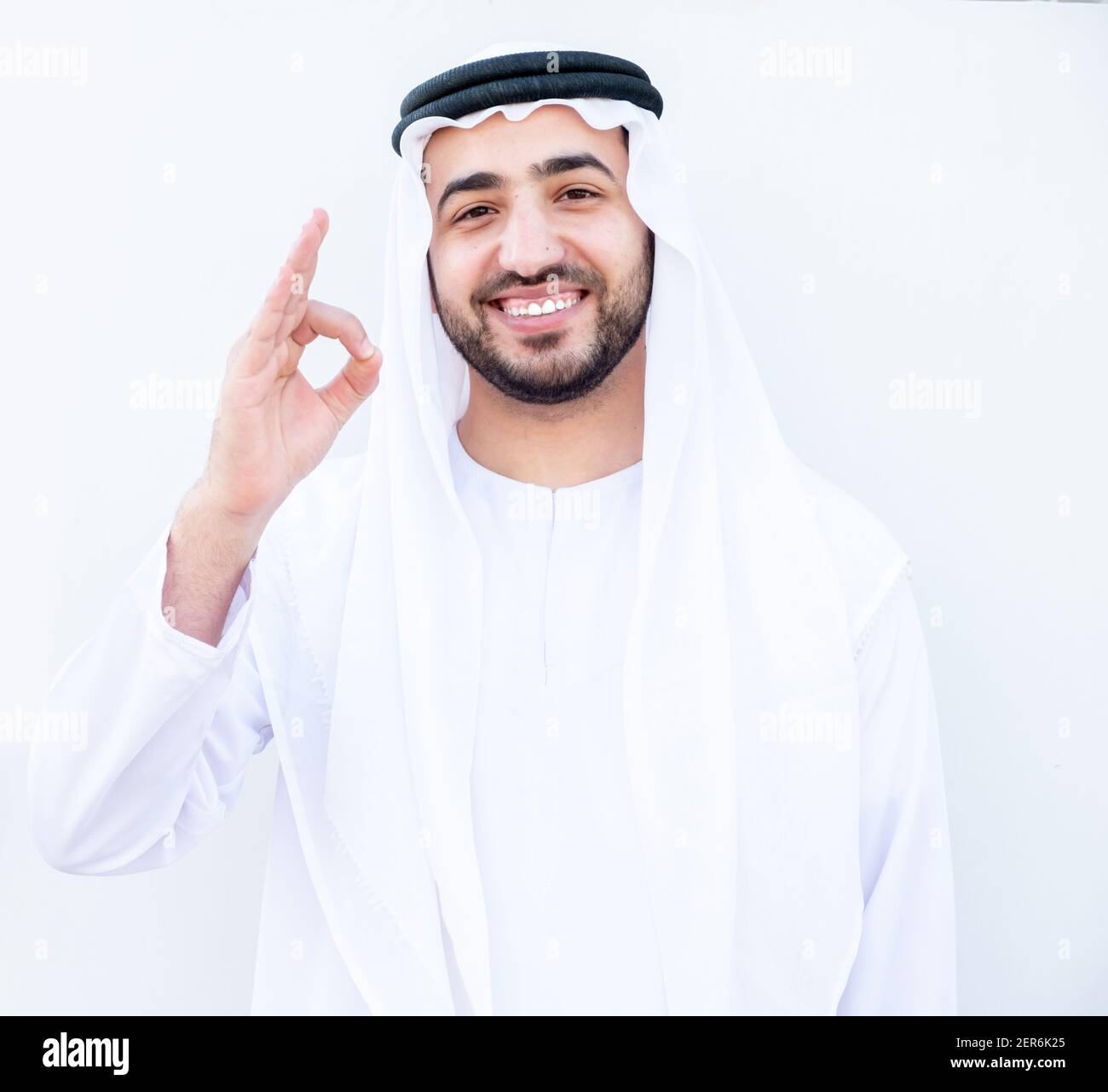 Arabic guy doing an admiration symbol Stock Photo - Alamy