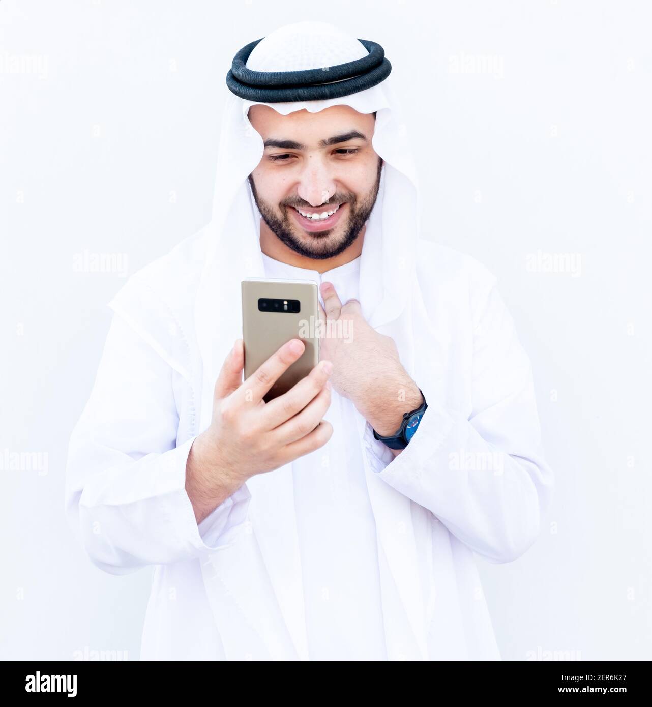 Arabic muslim guy using his smart phone to communicate with people ...