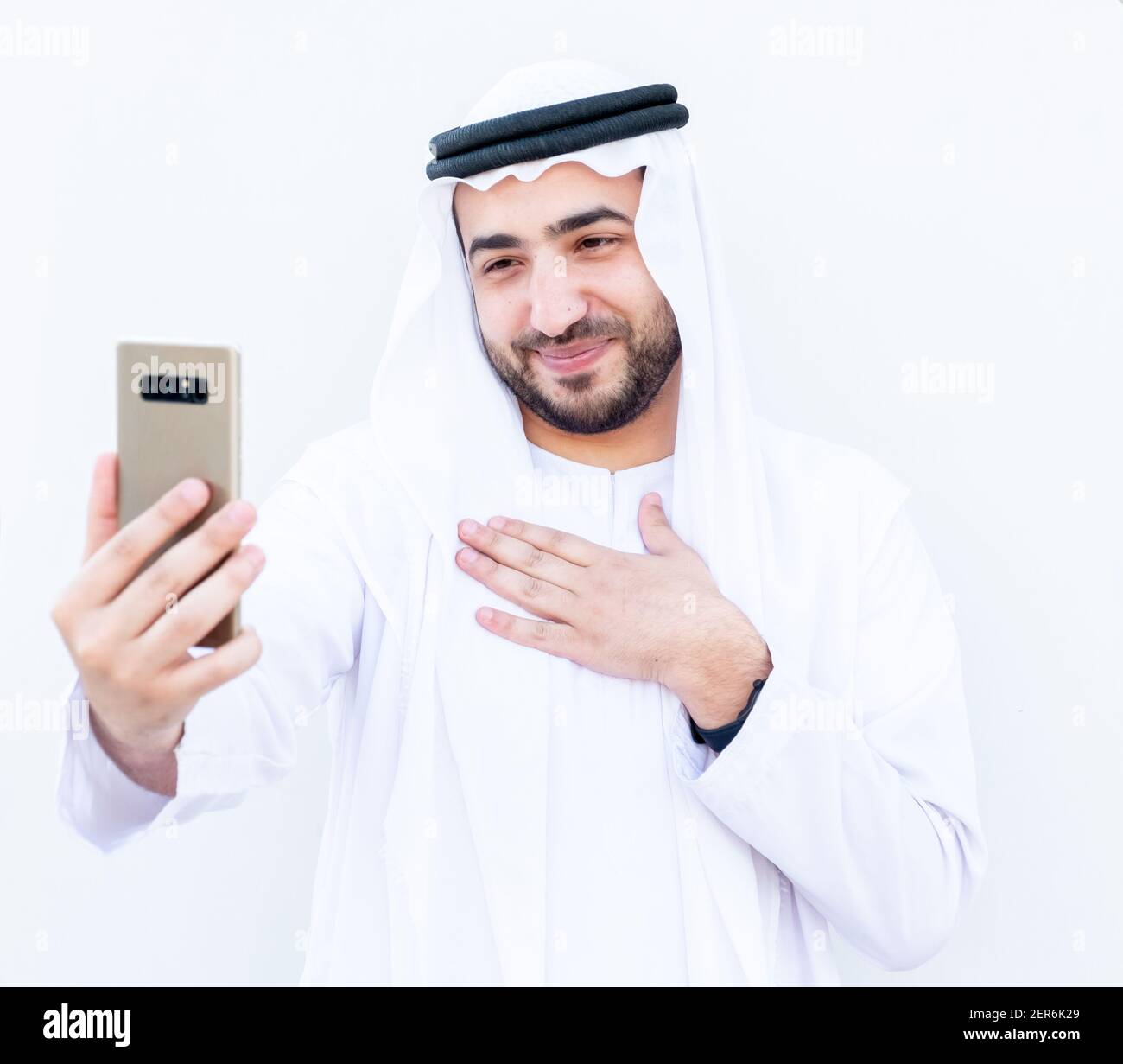 Arabic muslim guy using his smart phone to communicate with people ...