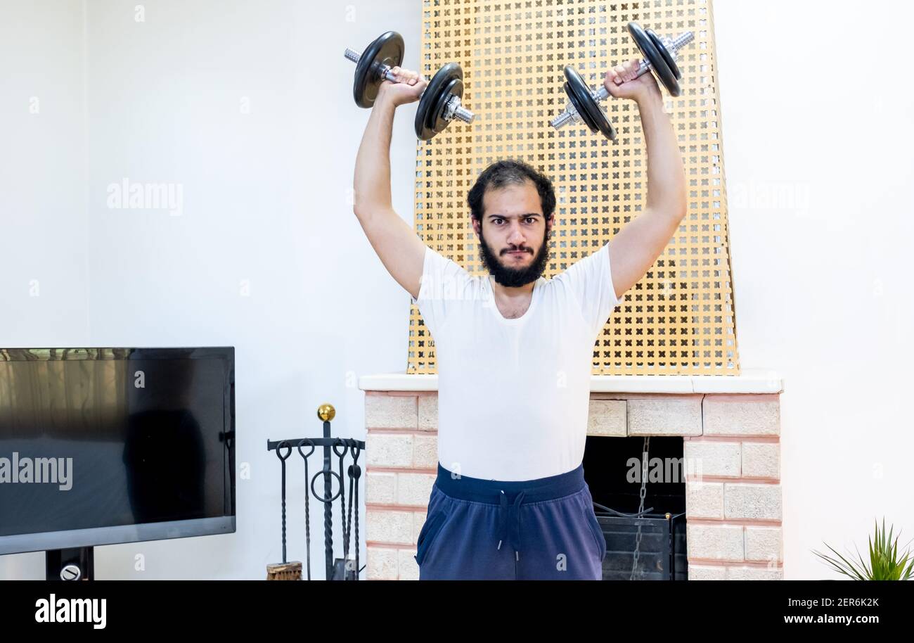 Athletic guy training hard at his home Stock Photo - Alamy