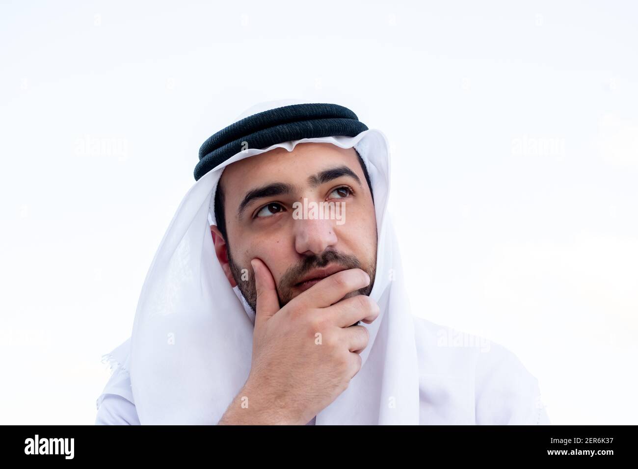 Arabic guy sitting and thinking of something Stock Photo - Alamy