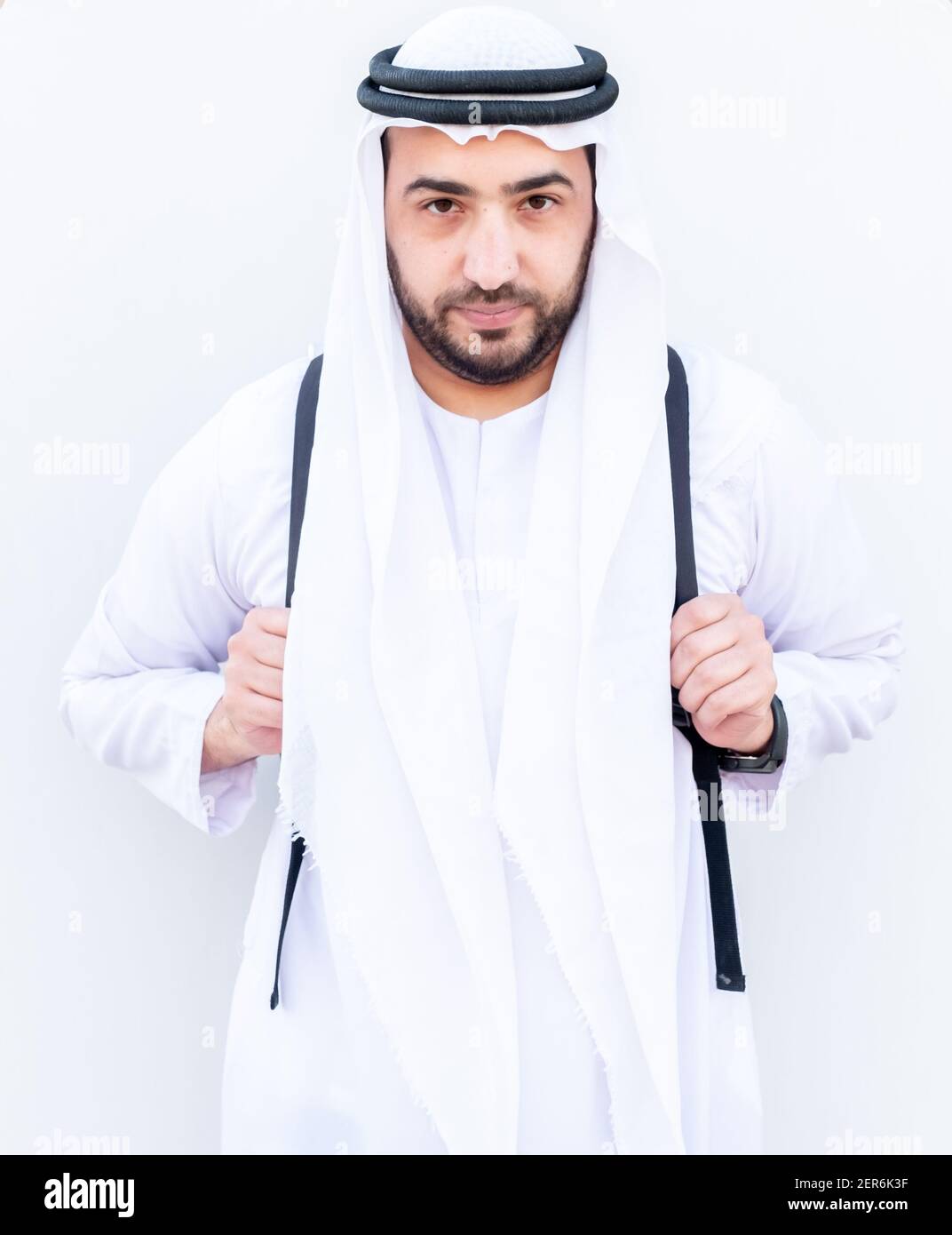Arabic guy wearing his backpack and preparing to school Stock Photo - Alamy