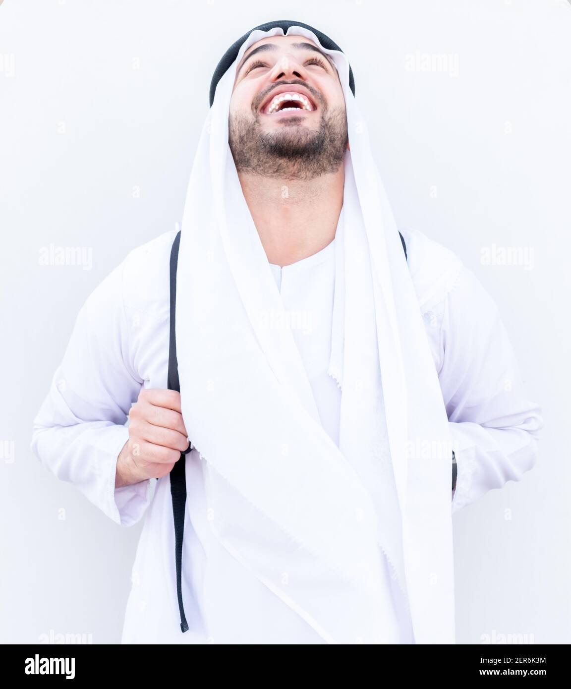 Arabic guy wearing his backpack and preparing to school Stock Photo - Alamy
