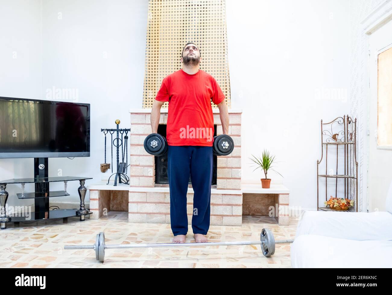 Athletic guy training hard at his home Stock Photo - Alamy
