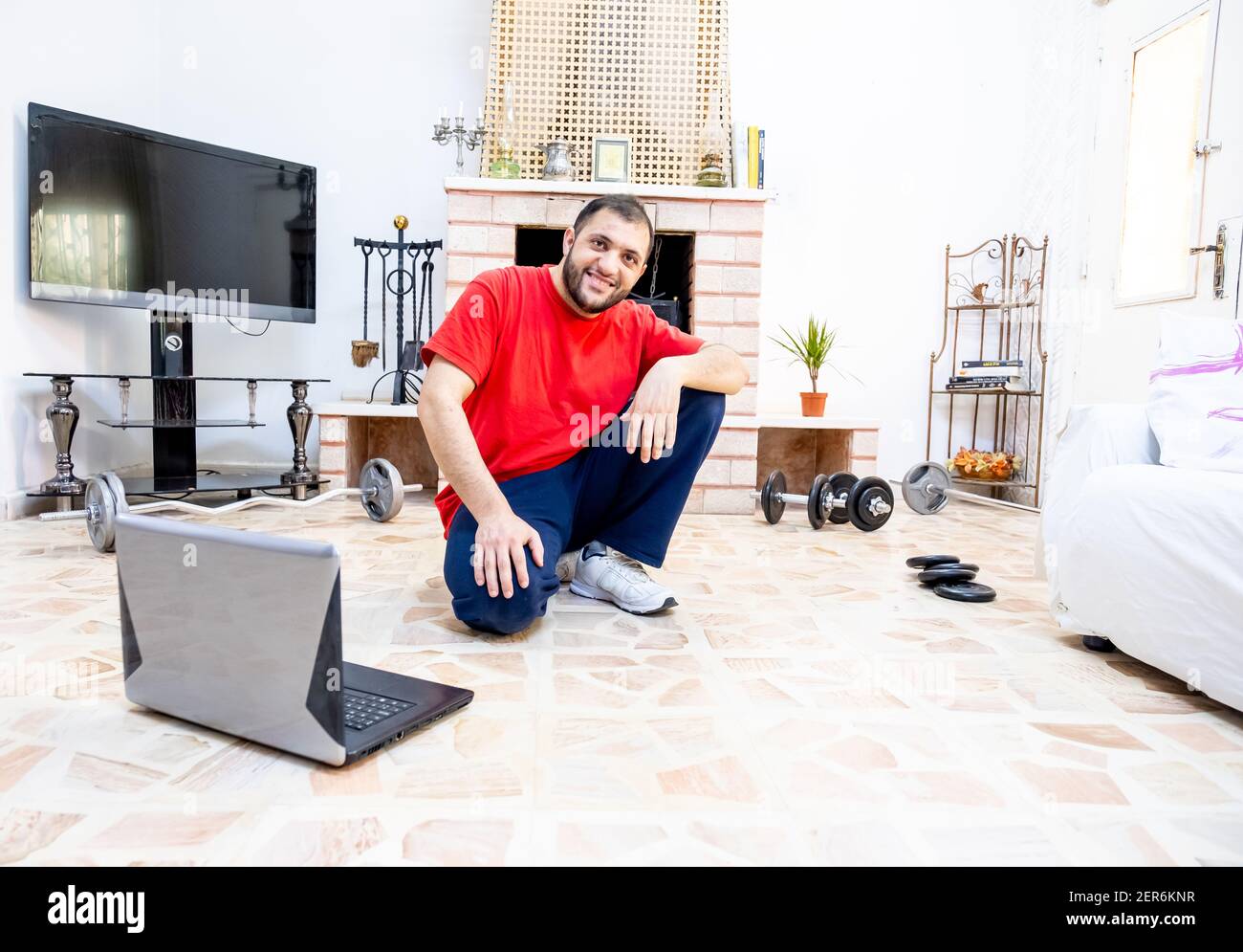 Athletic guy watching video tutorial to work out Stock Photo - Alamy