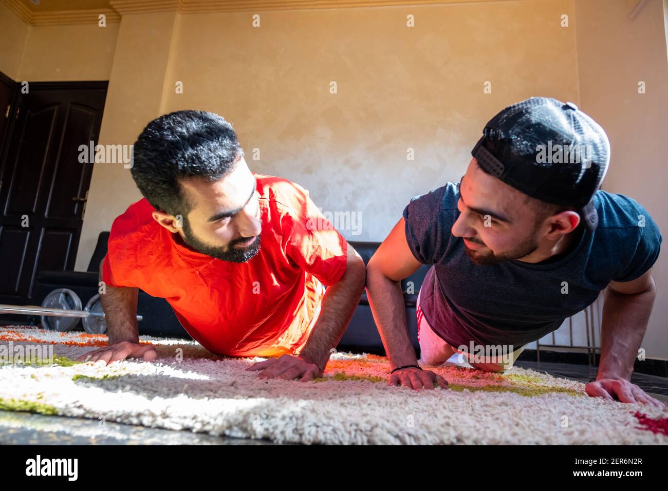 Two brothers weight lifting and doing sports together at home Stock ...