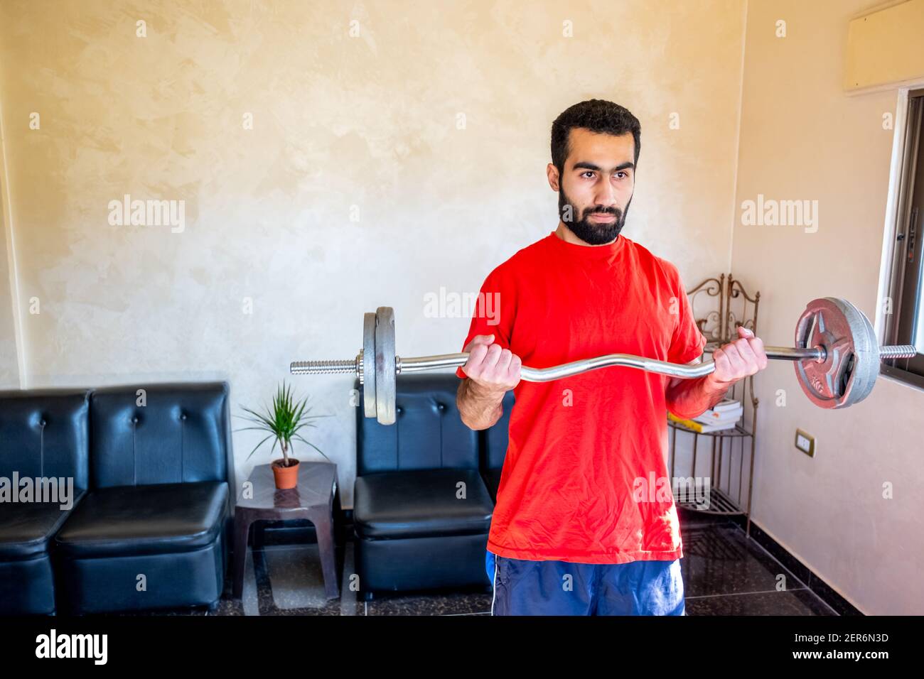 Guy doing some training at home to keep in good shape Stock Photo - Alamy