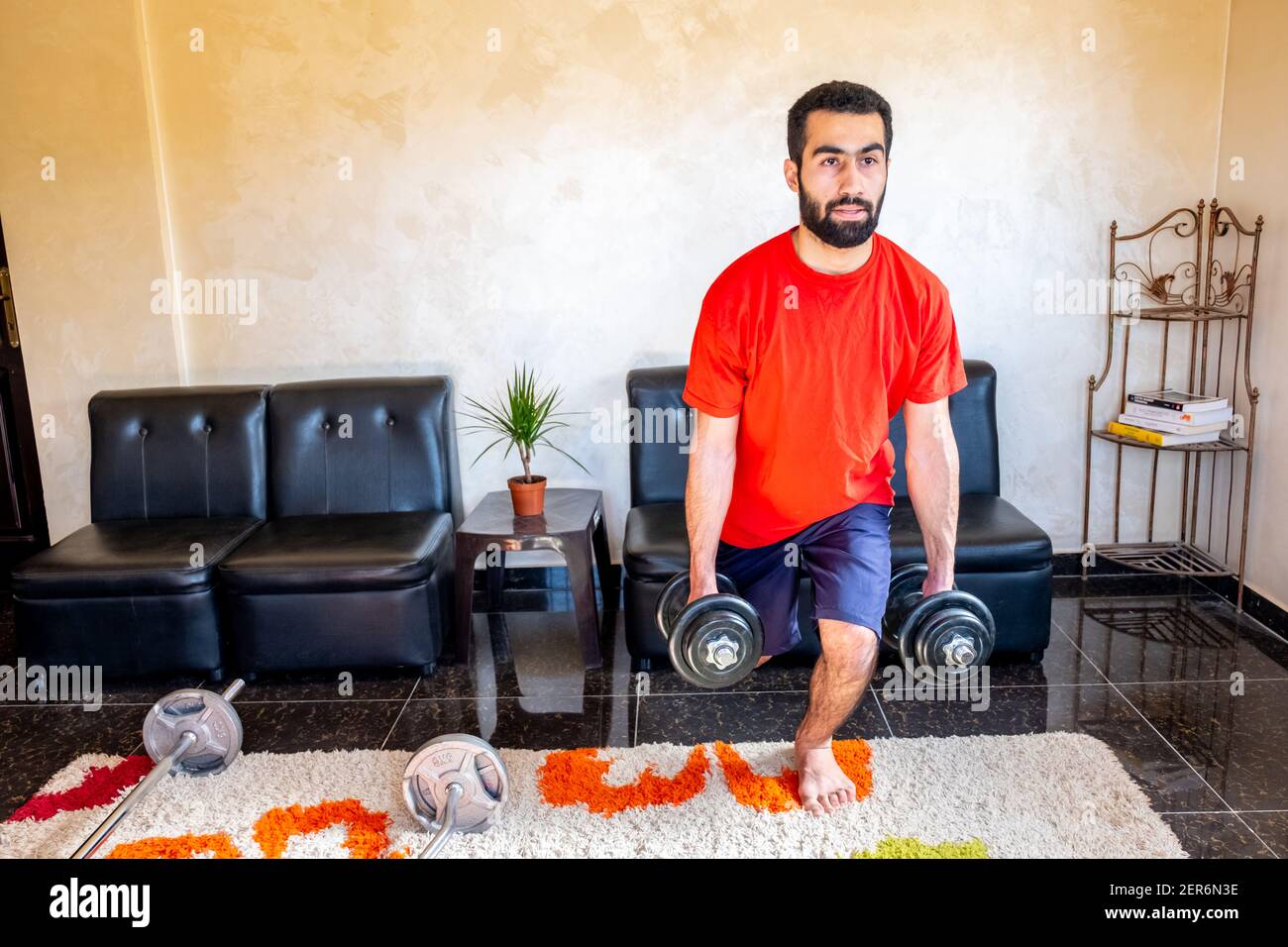 Guy doing some training at home to keep in good shape Stock Photo - Alamy