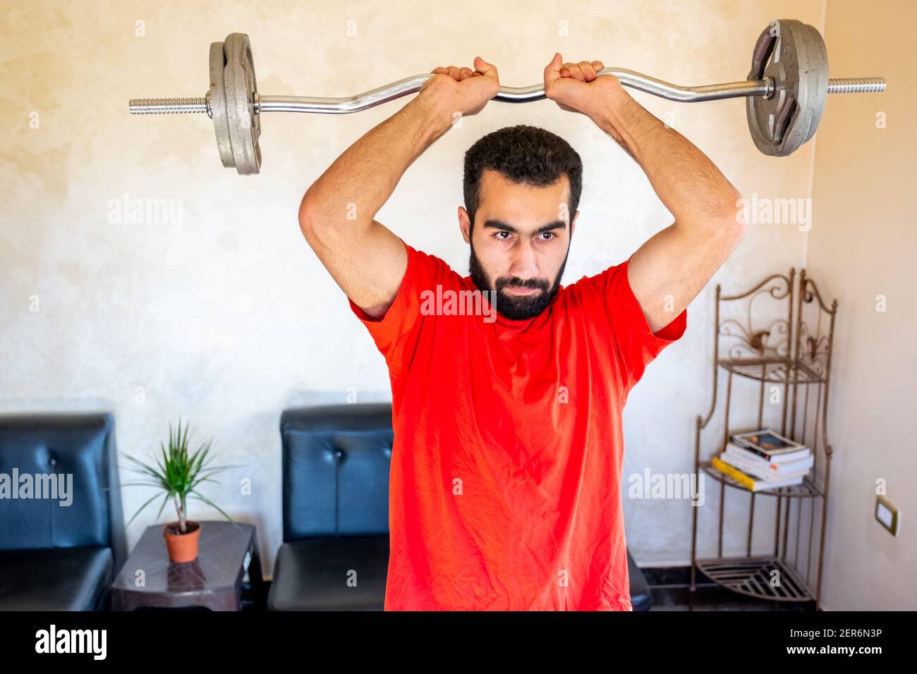 Guy doing some training at home to keep in good shape Stock Photo - Alamy