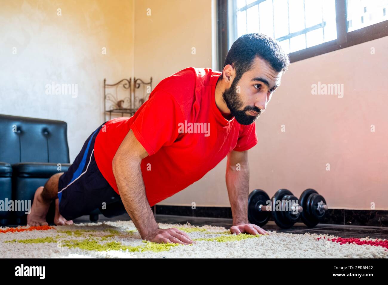 Guy doing some training at home to keep in good shape Stock Photo - Alamy