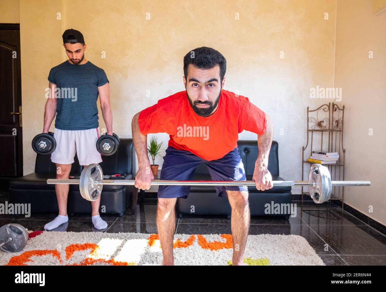 Two brothers weight lifting and doing sports together at home Stock ...