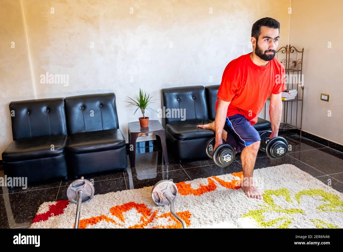 Guy doing some training at home to keep in good shape Stock Photo - Alamy