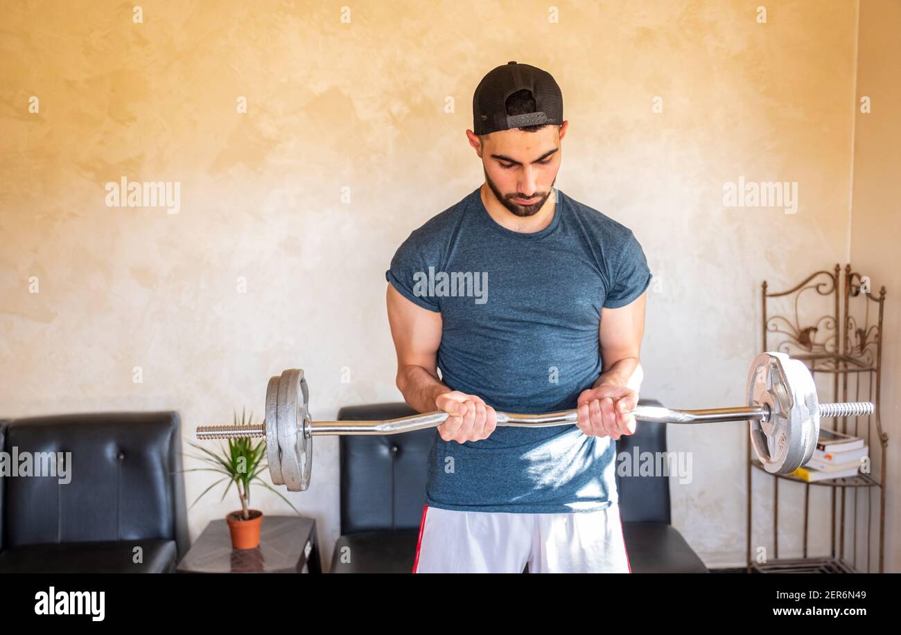 Guy doing some training at home to keep in good shape Stock Photo - Alamy