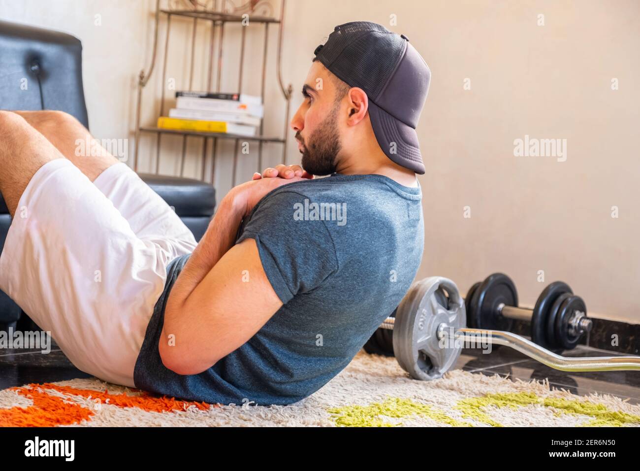 Guy doing some training at home to keep in good shape Stock Photo - Alamy