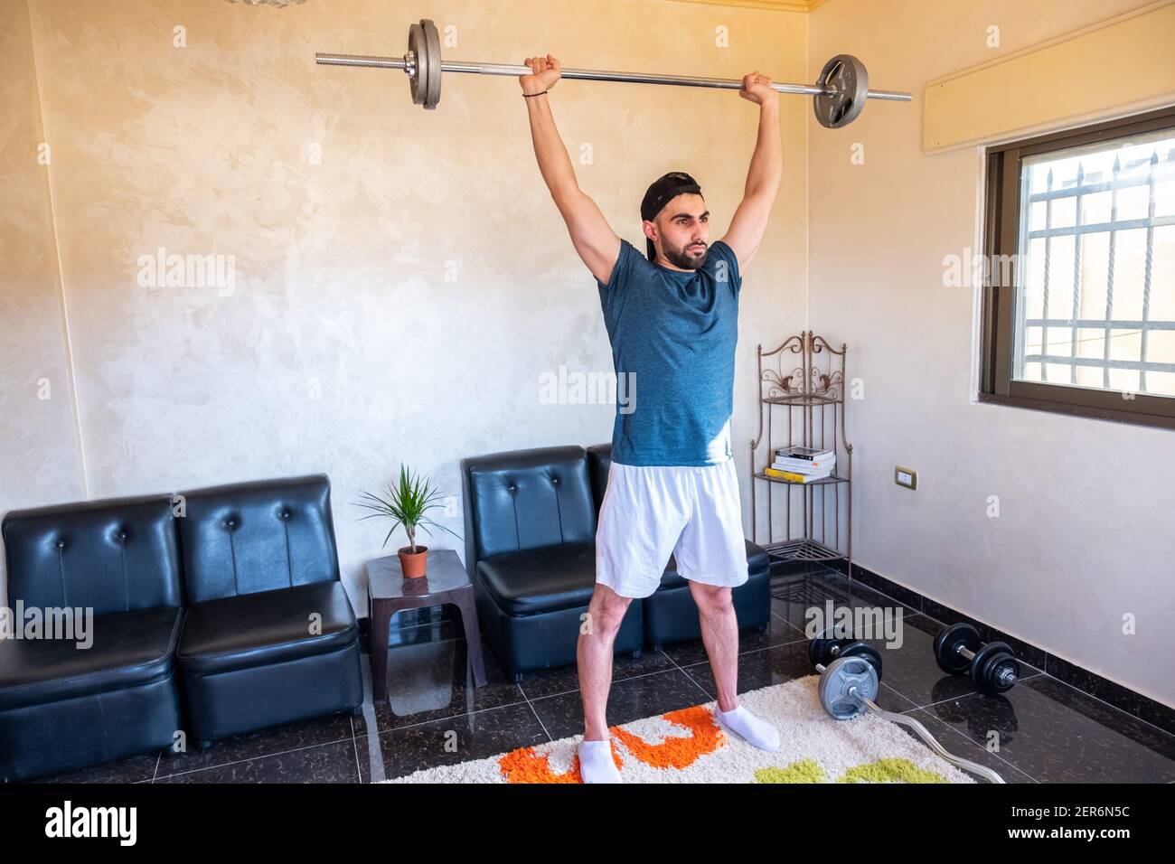 Guy doing some training at home to keep in good shape Stock Photo - Alamy