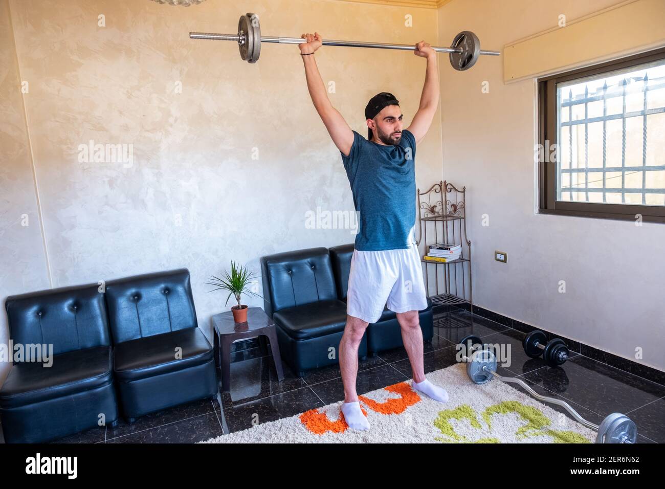 Guy doing some training at home to keep in good shape Stock Photo - Alamy