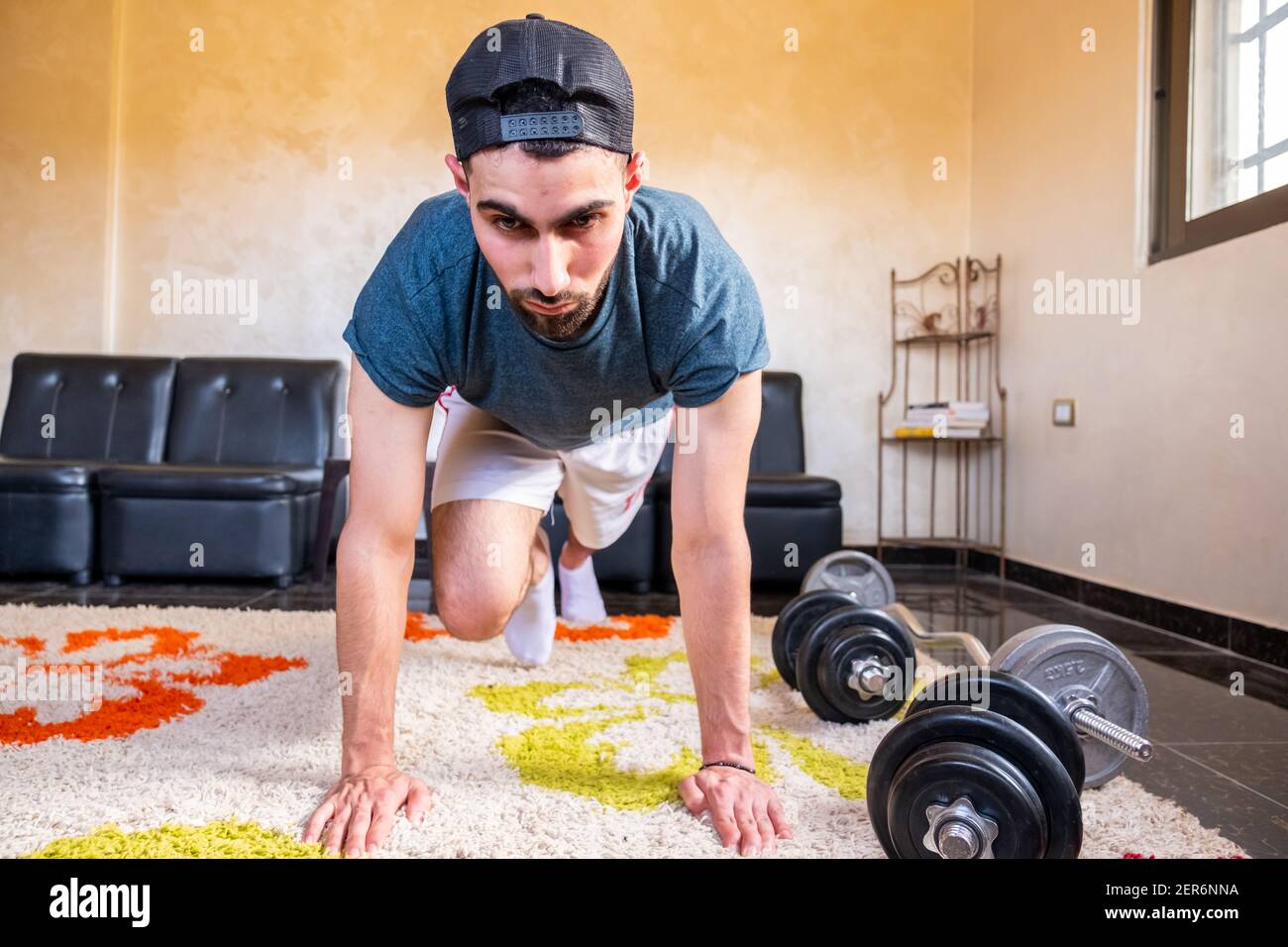 Guy doing some training at home to keep in good shape Stock Photo - Alamy