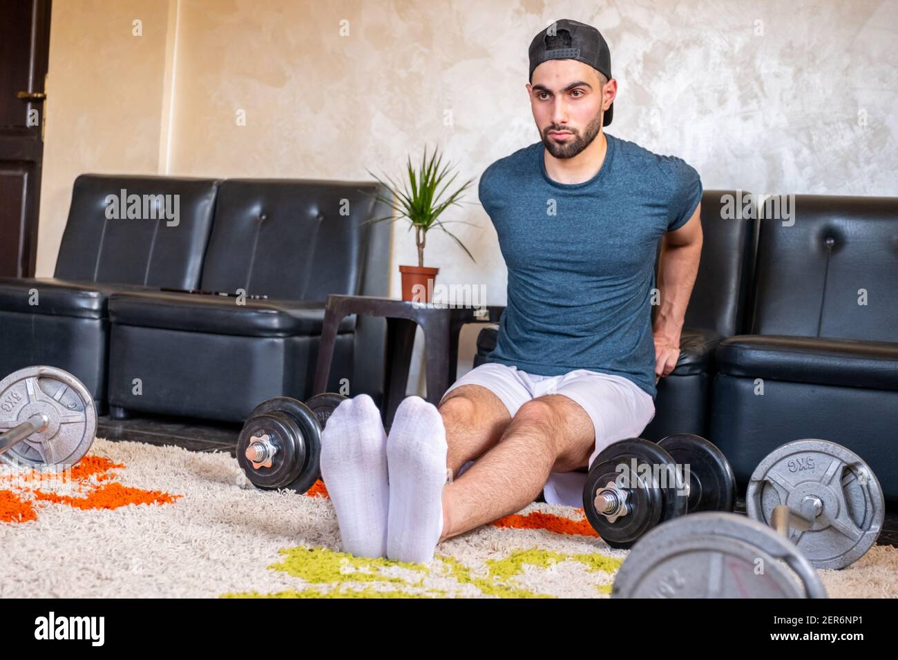 Guy doing some training at home to keep in good shape Stock Photo - Alamy
