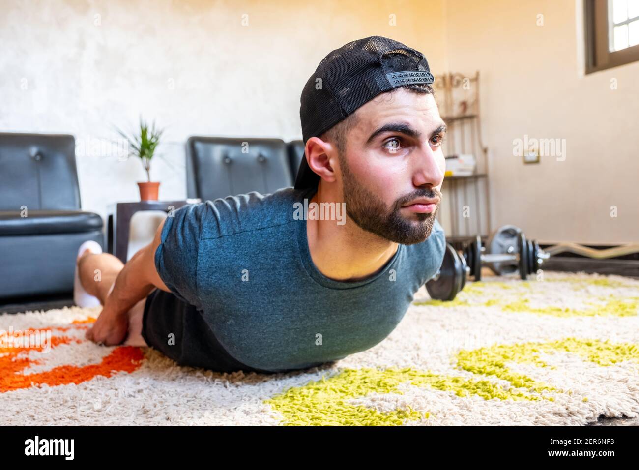 Guy doing some training at home to keep in good shape Stock Photo - Alamy