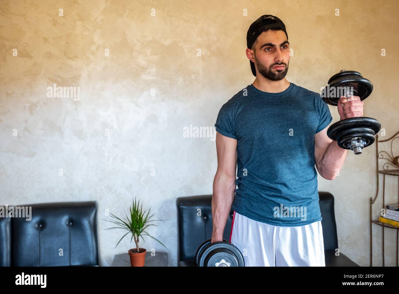 Guy doing some training at home to keep in good shape Stock Photo - Alamy