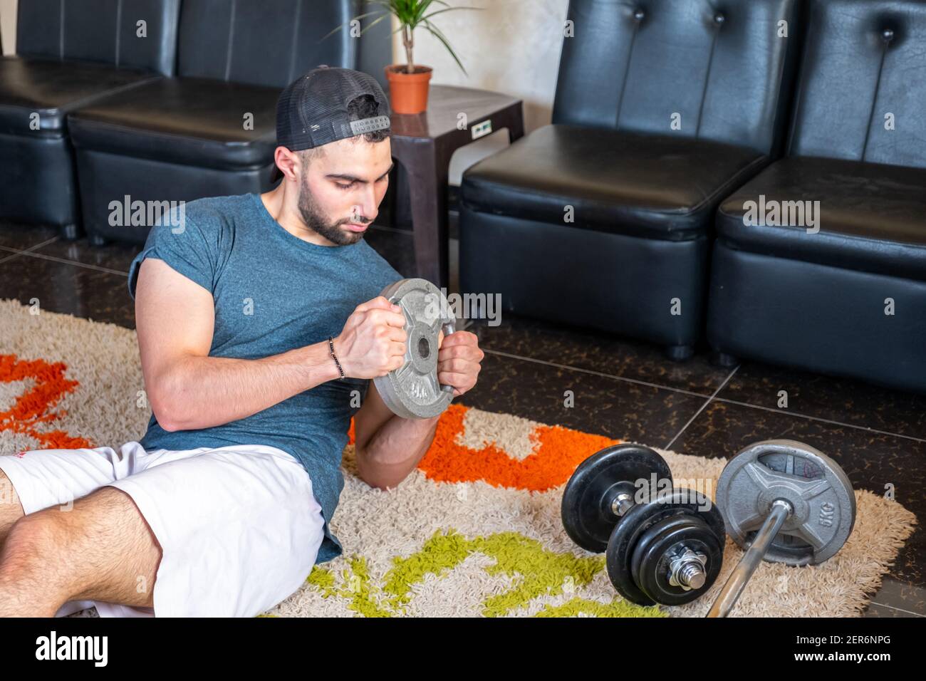 Guy doing some training at home to keep in good shape Stock Photo - Alamy