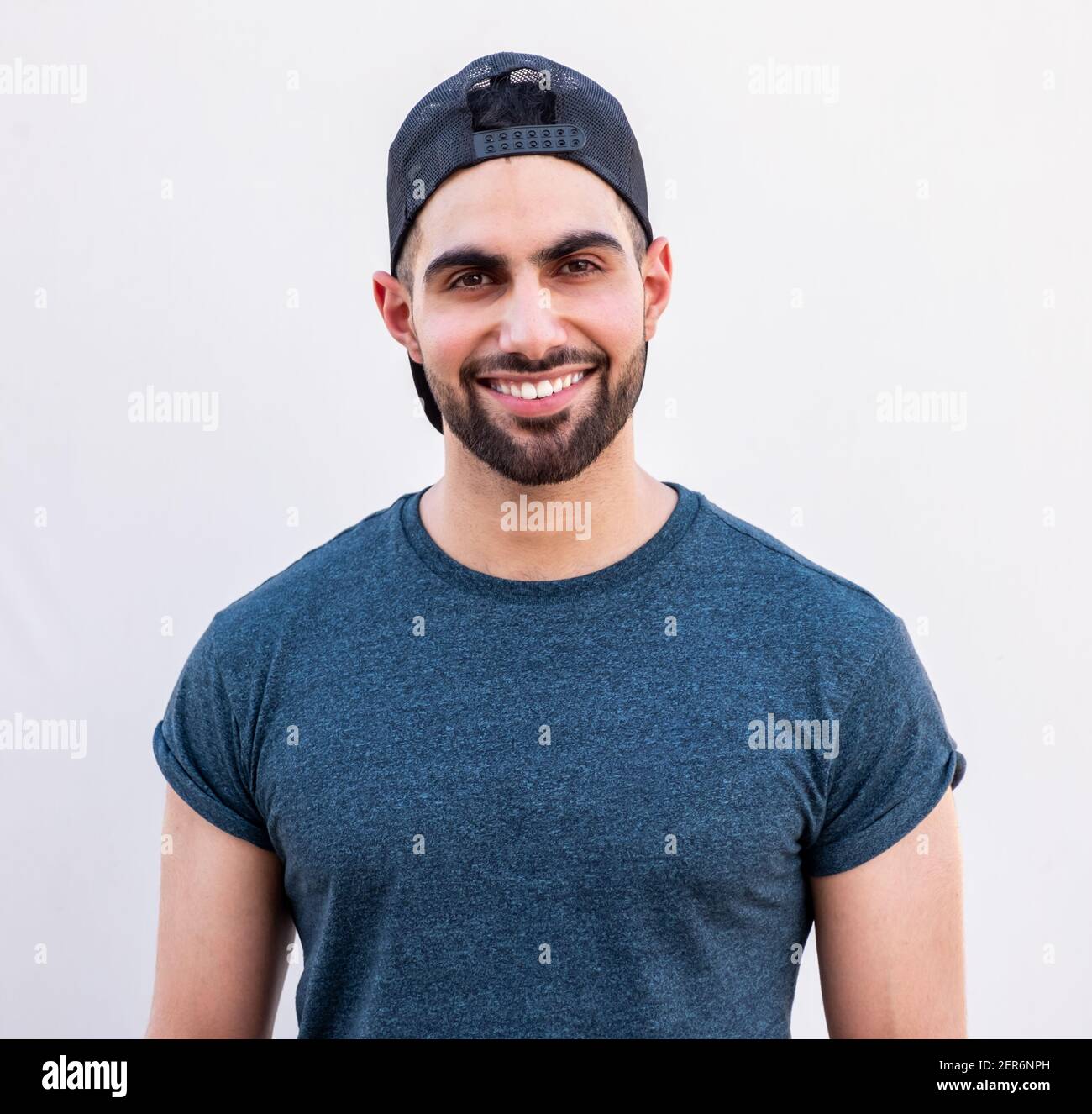 Portrait of happy guy smiling wearing a hat Stock Photo - Alamy