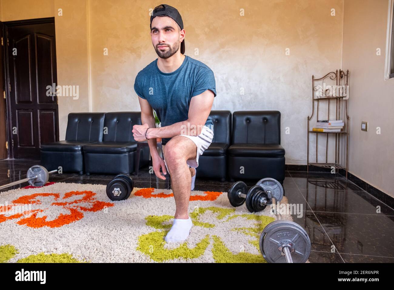 Guy doing some training at home to keep in good shape Stock Photo - Alamy
