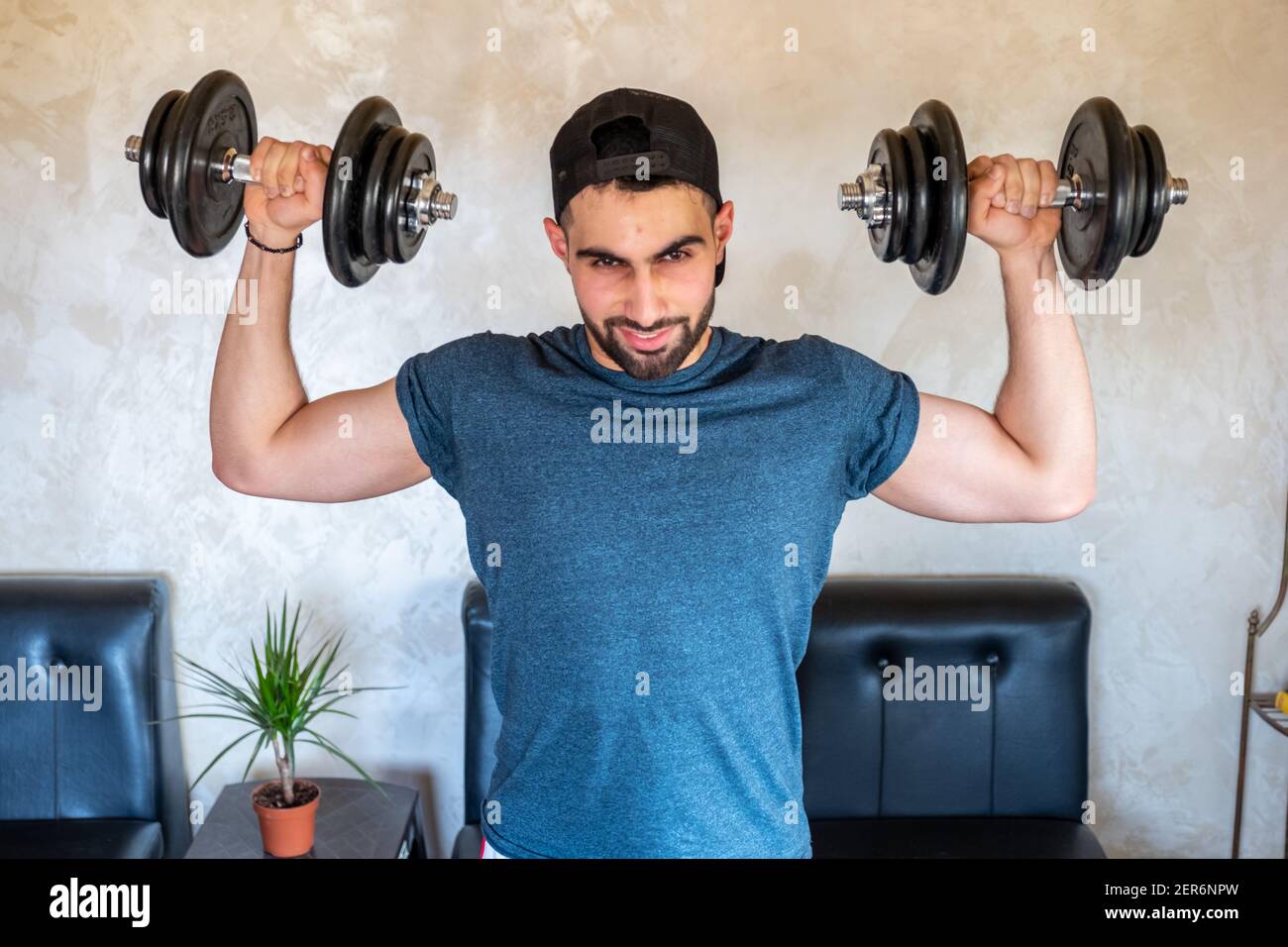 Guy doing some training at home to keep in good shape Stock Photo - Alamy