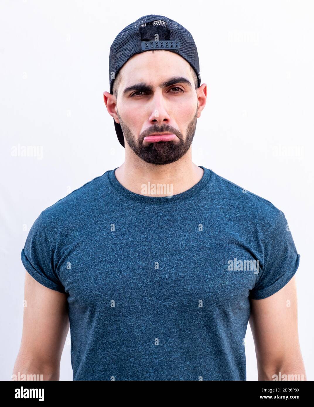 Guy making an expression of being angry and sad Stock Photo - Alamy