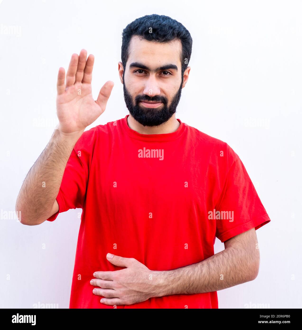Guy standing and waving his to say hi Stock Photo - Alamy