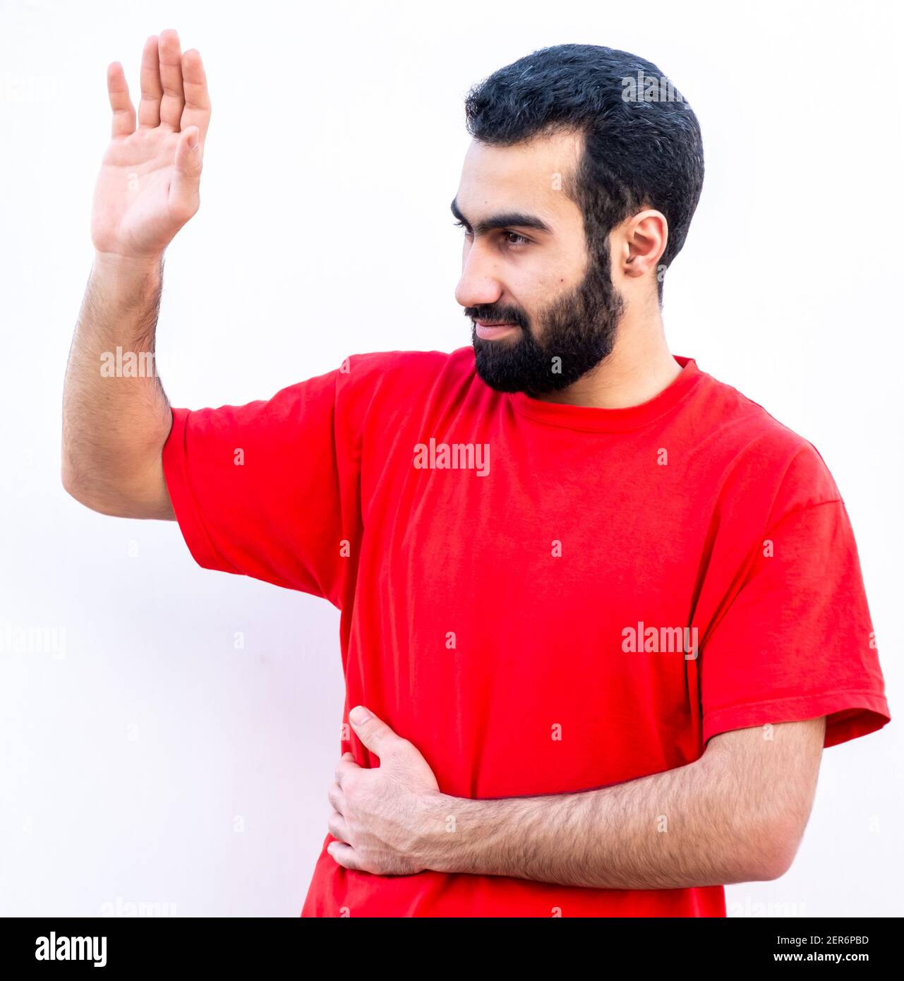 Guy standing and waving his to say hi Stock Photo - Alamy
