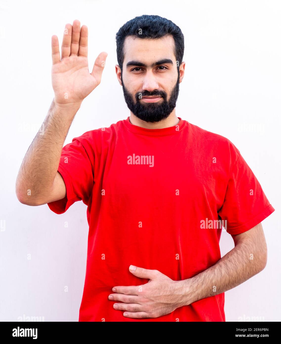Guy standing and waving his to say hi Stock Photo - Alamy
