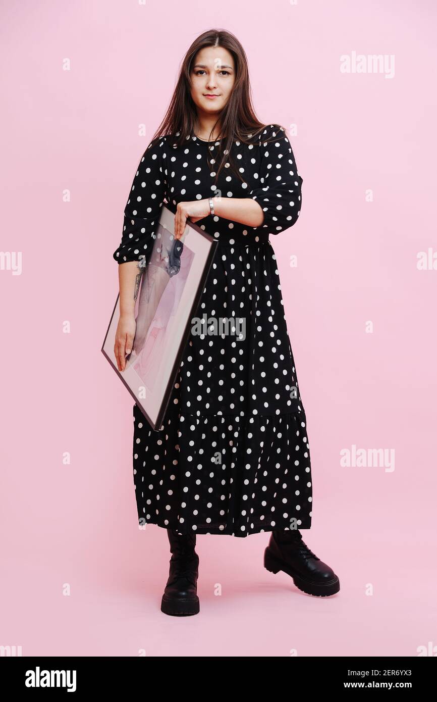 Creative girl artist with a painting in her hands, full-length portrait ...