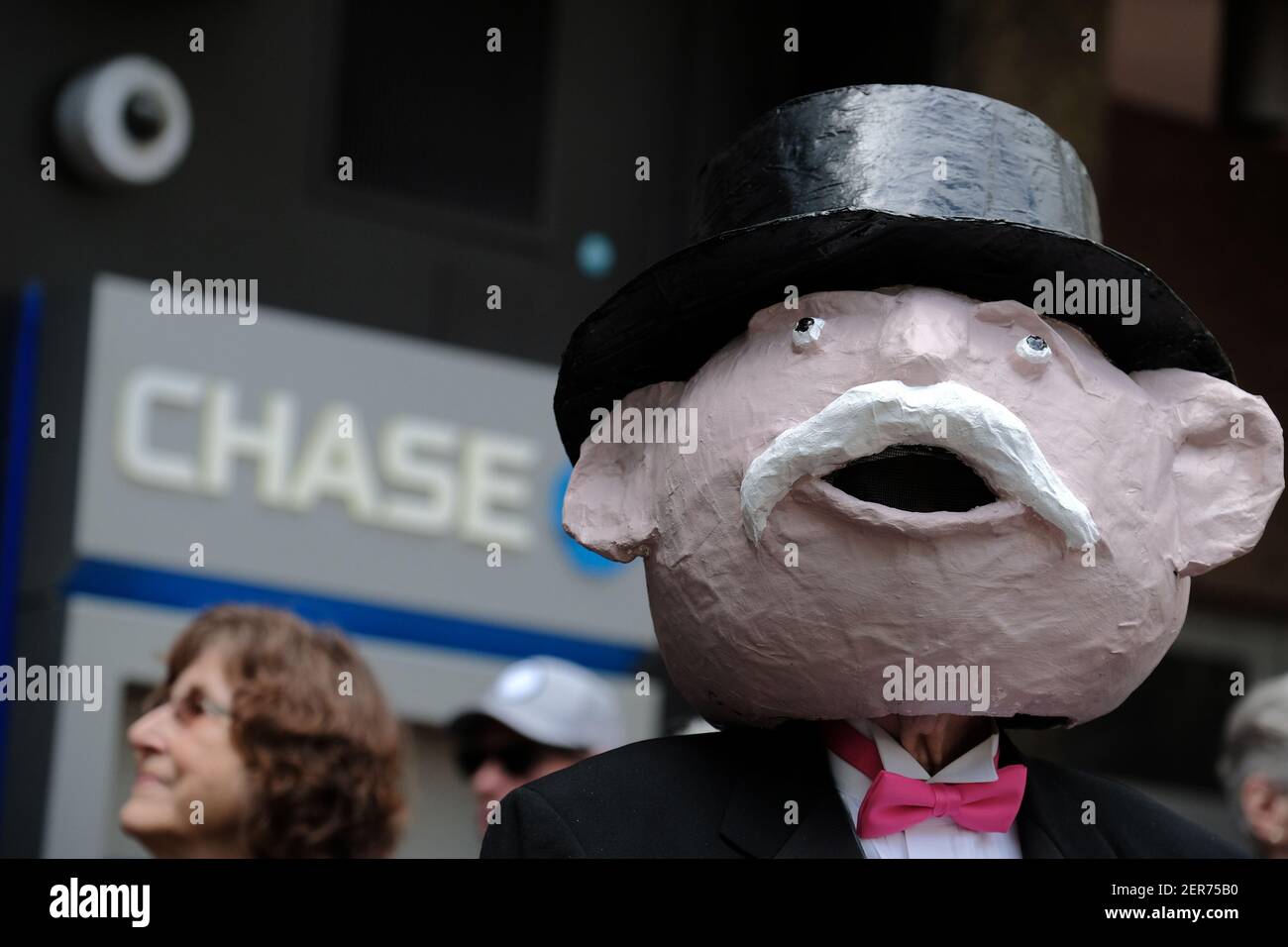 An activist dressed as the Monopoly man demonstrates outside the ...