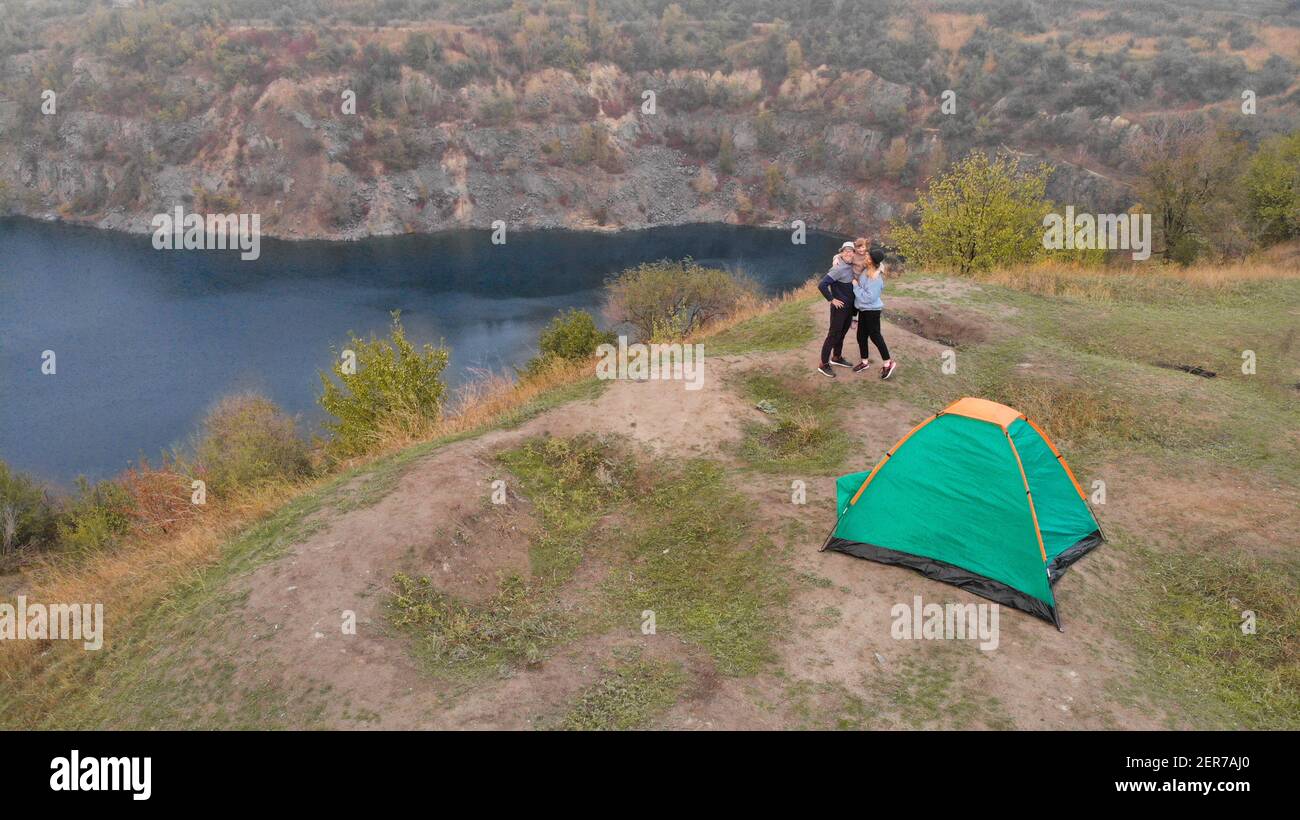 Aerial top view of family in campsite from above, parents and kid relax ...
