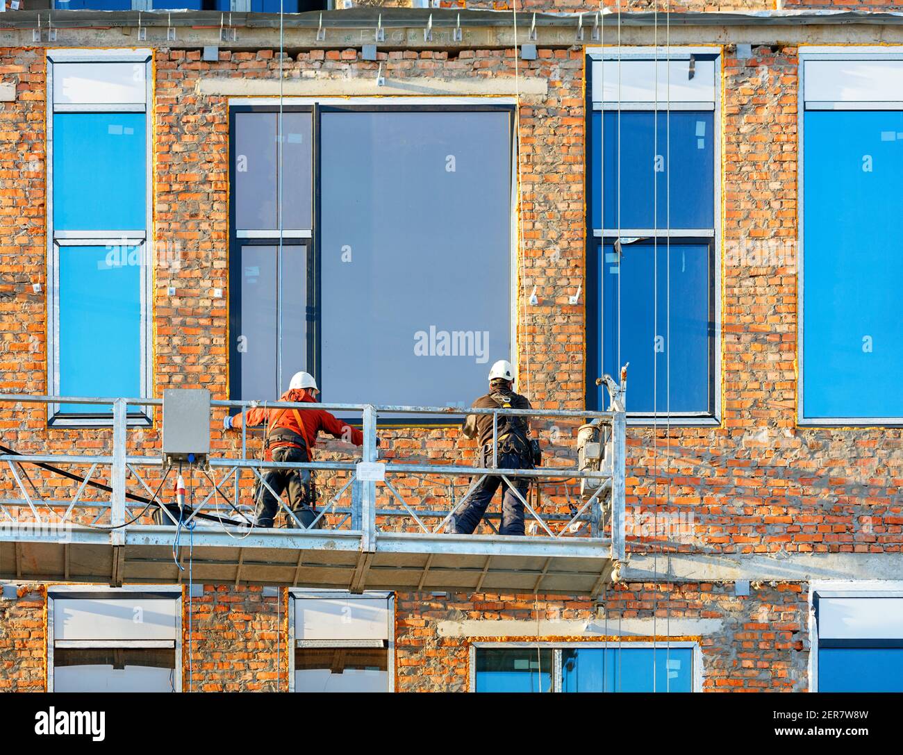Renovation of the facade and installation of large windows in a modern ...
