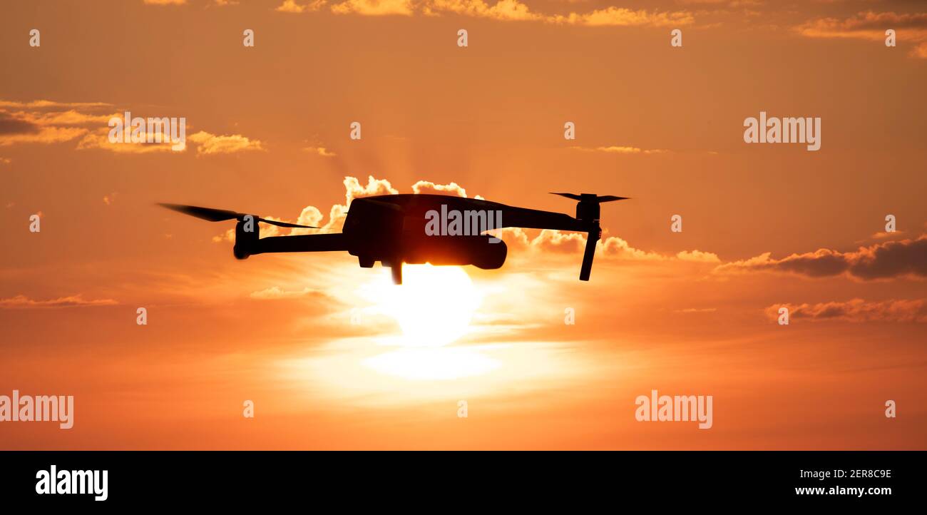 Quadcopter or drone on a sunset background Stock Photo - Alamy